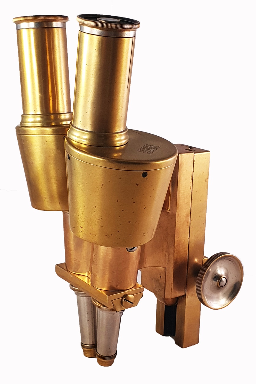 A close-up of a gold microscopeDescription automatically generated with ...