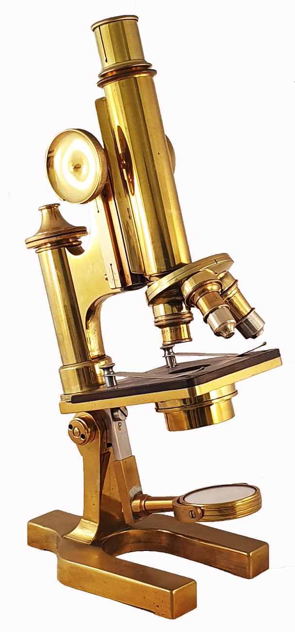 A close-up of a gold microscopeDescription automatically generated